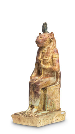 Bonhams : An Egyptian inlaid bichrome faience enthroned Bastet with ...