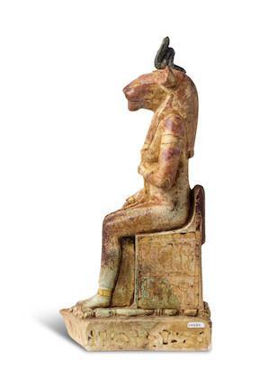 Bonhams : An Egyptian inlaid bichrome faience enthroned Bastet with ...