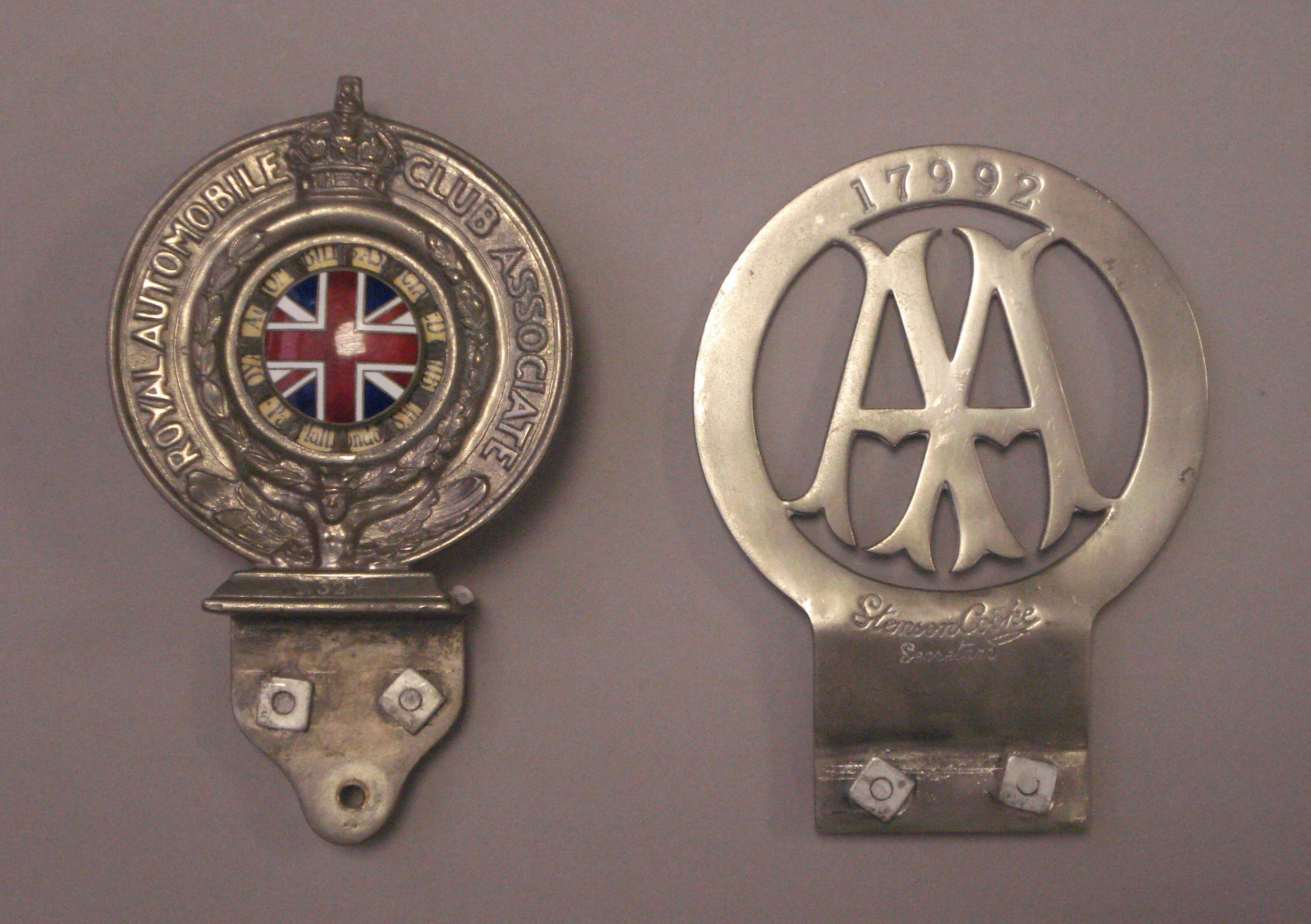 Bonhams Cars : An RAC and an AA badge.