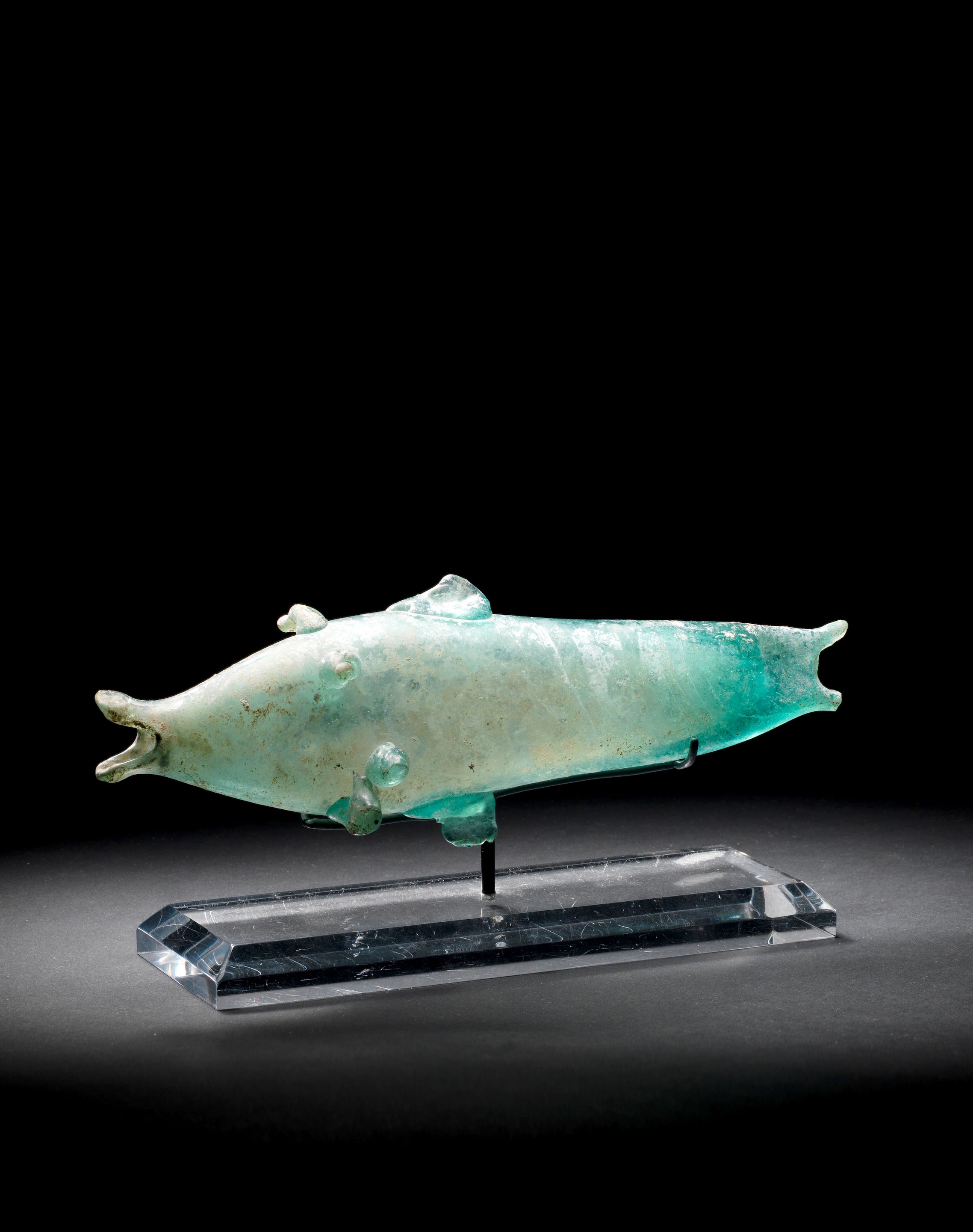 Bonhams : A Roman bluish-green glass fish vessel