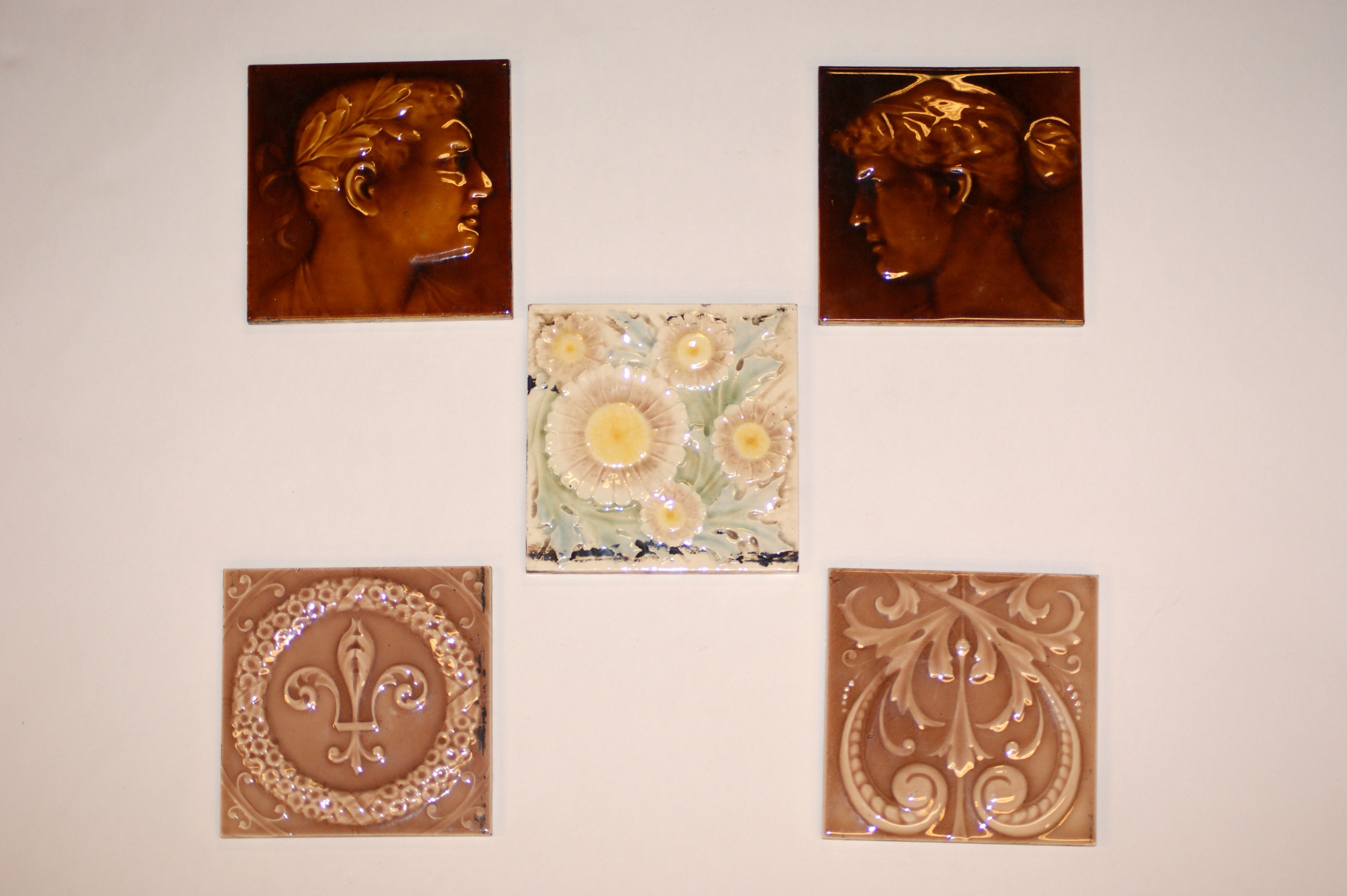 Bonhams : Two American Encaustic Co Ltd Brown glazed portrait tiles