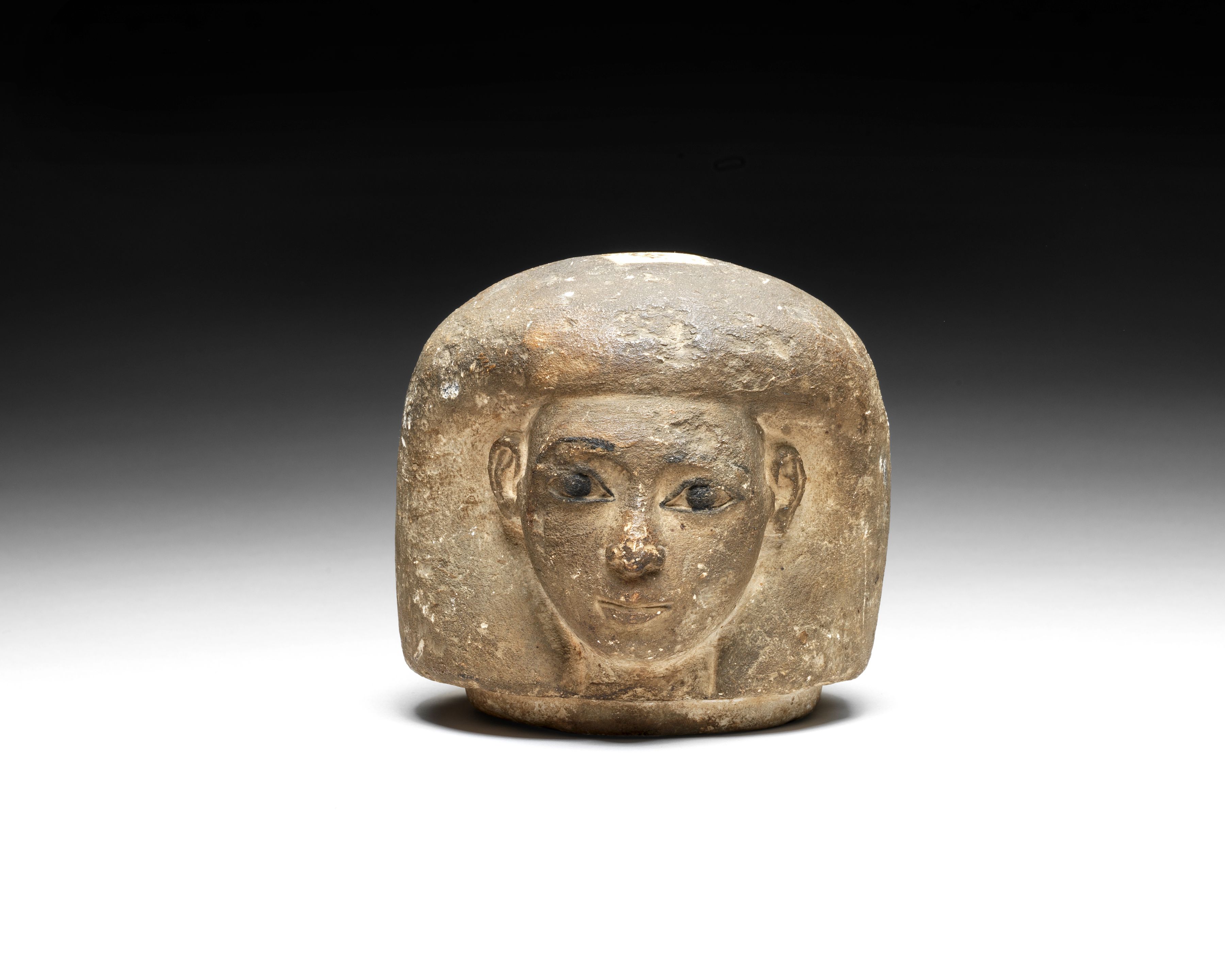 Bonhams : An Egyptian limestone canopic jar head of Imsety