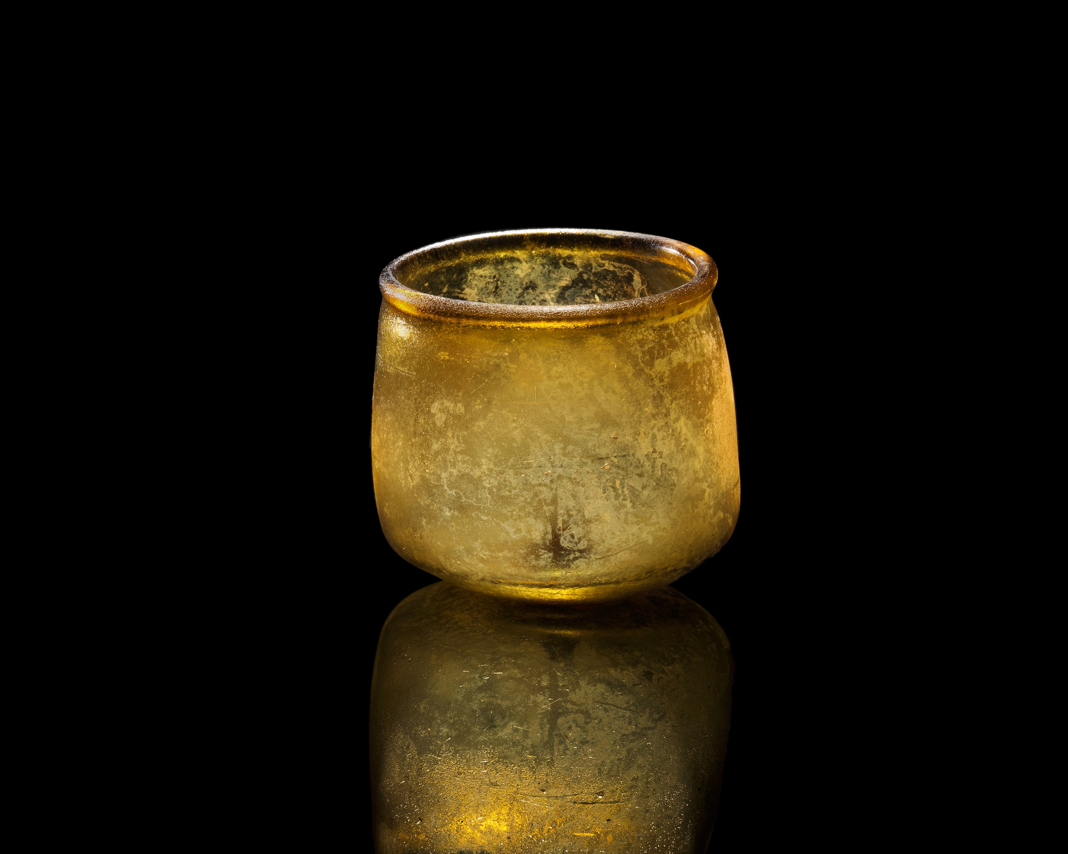 Bonhams : A Roman amber glass beaker