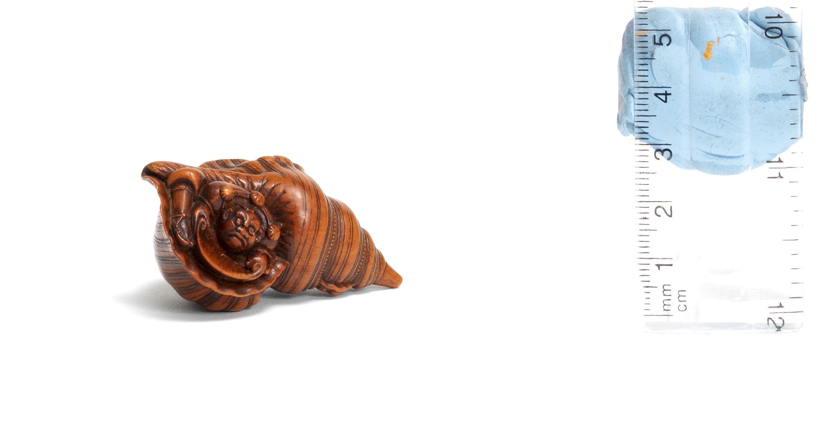 Bonhams : A boxwood netsuke of Benkei in a conch shell Early 19th century