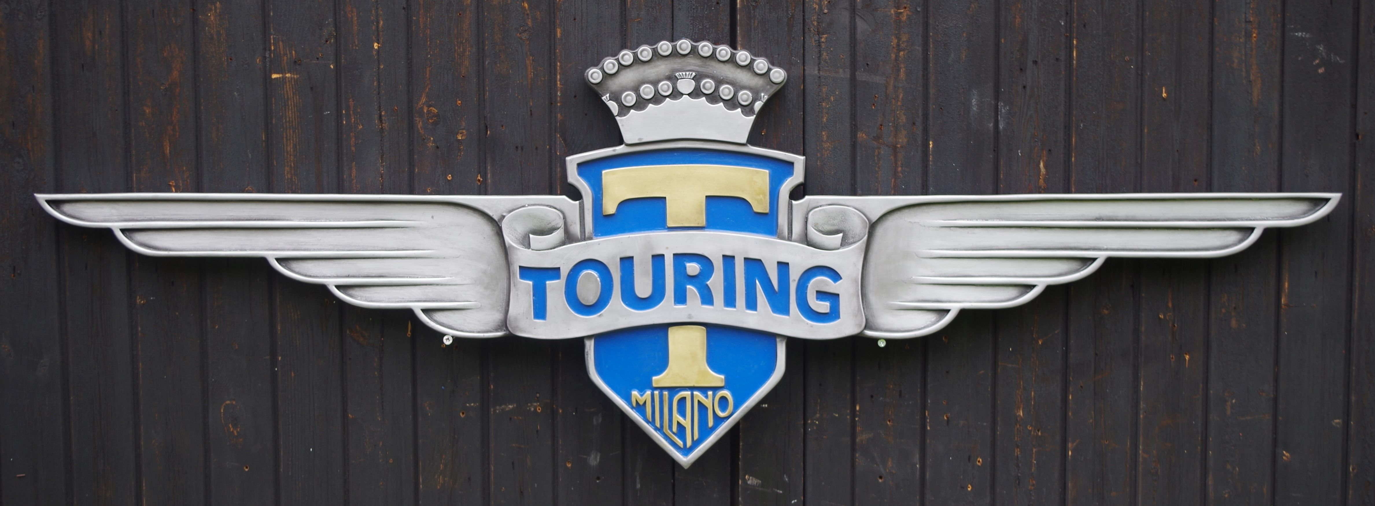 Bonhams Cars : A 'Touring Milano' garage display emblem,