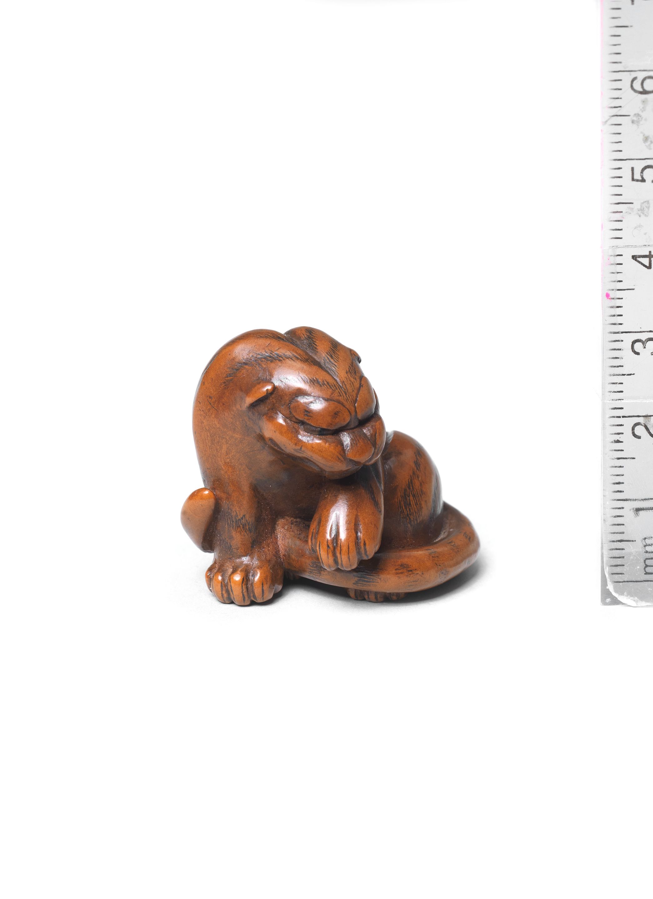 Bonhams : A boxwood netsuke of a tiger By Masataka, early 19th century