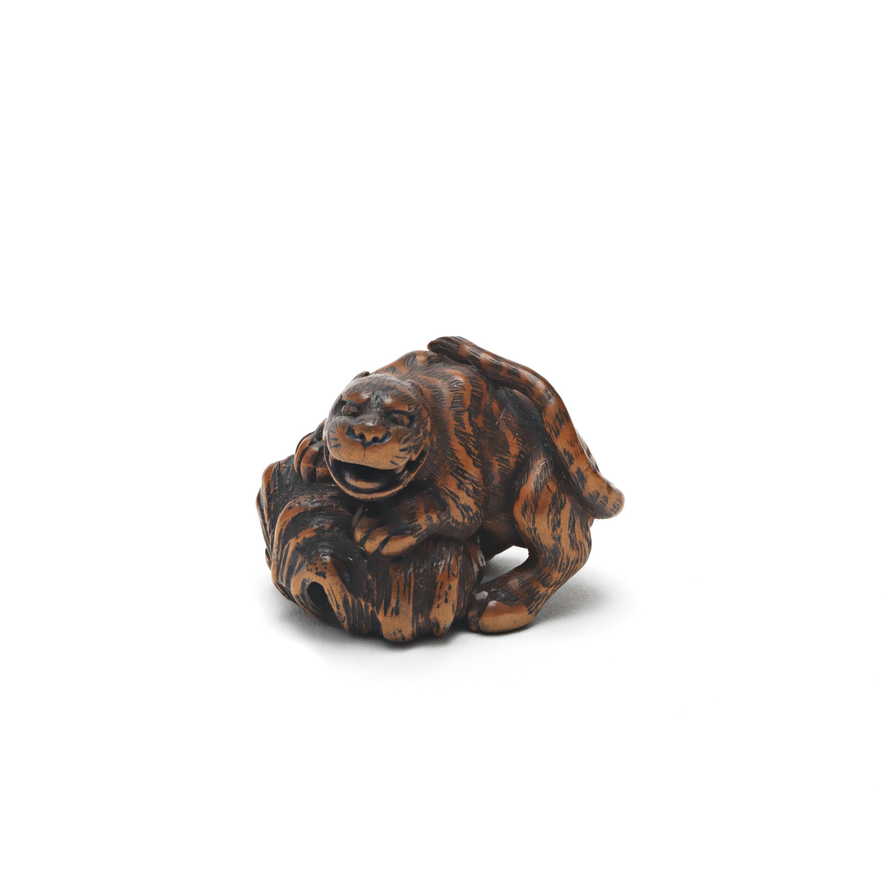 Bonhams : A WOOD NETSUKE OF A TIGER ON A ROCK By Kokei, Kuwana, Ise ...